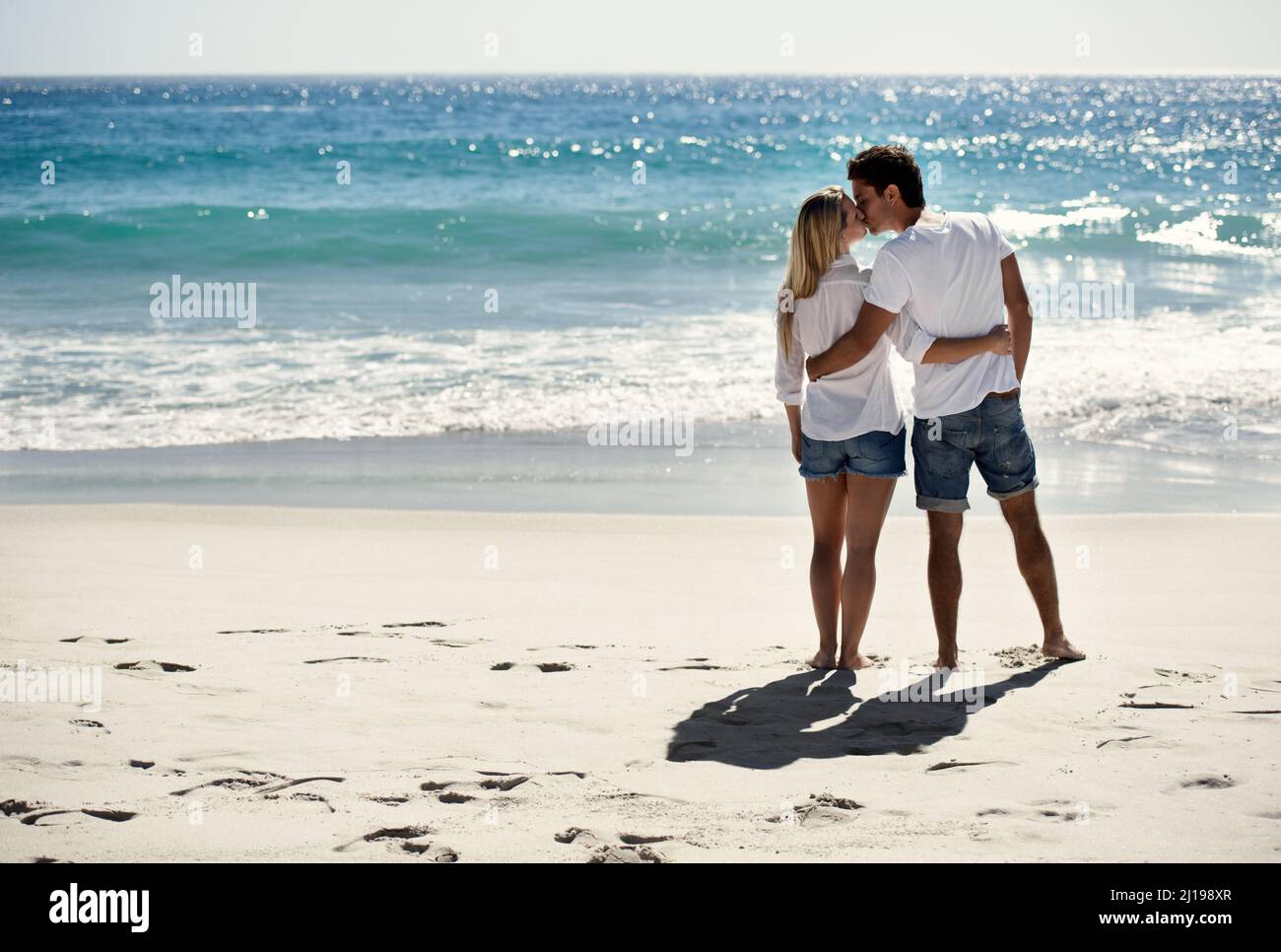 A loving moment in a peaceful place. A happy couple kissing on the ...