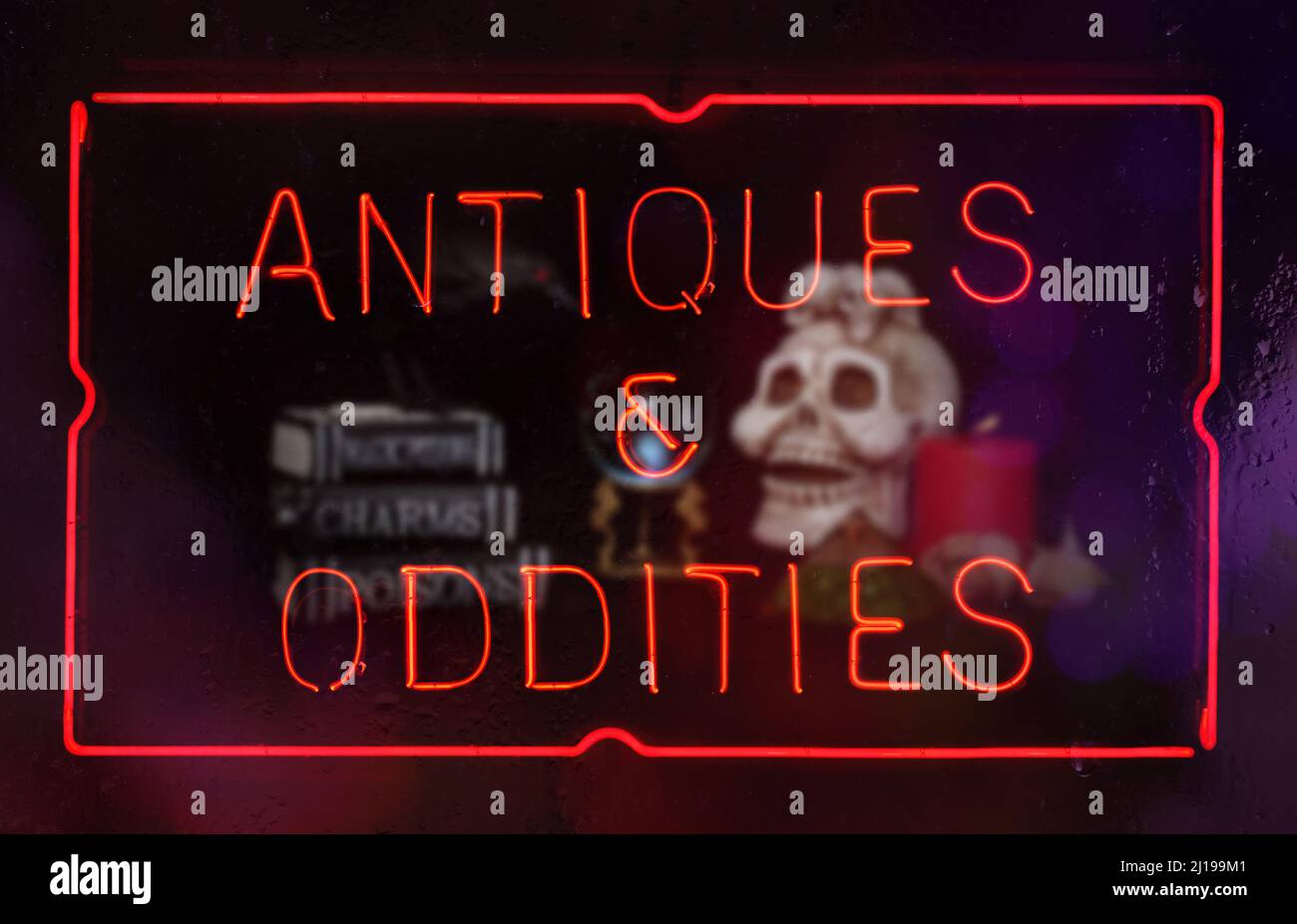 Oddities and Antiques Neon Sign in Rainy Shop Window Stock Photo - Alamy