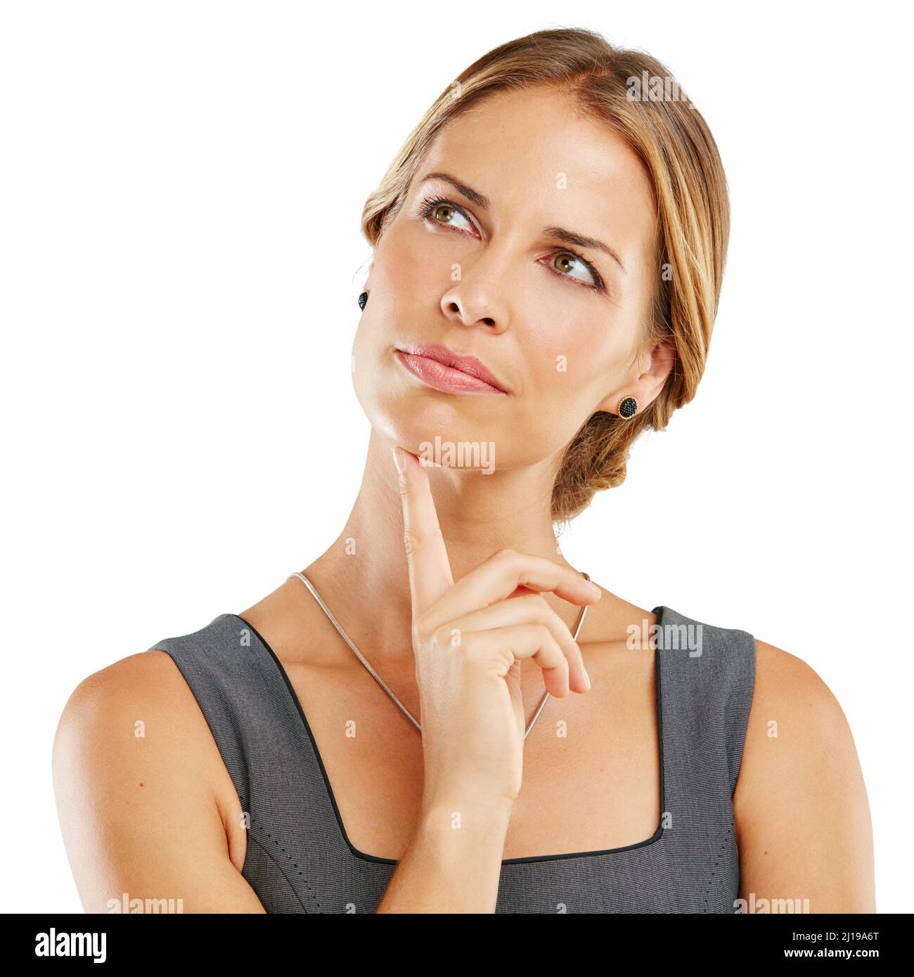 Hmmm... I wonder.... Studio shot of an attractive young businesswoman ...