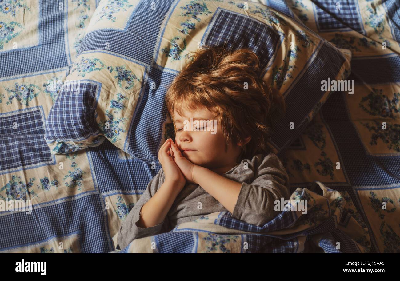 Cute child sleeping in the bed. Adorable small kids rest asleep enjoy ...