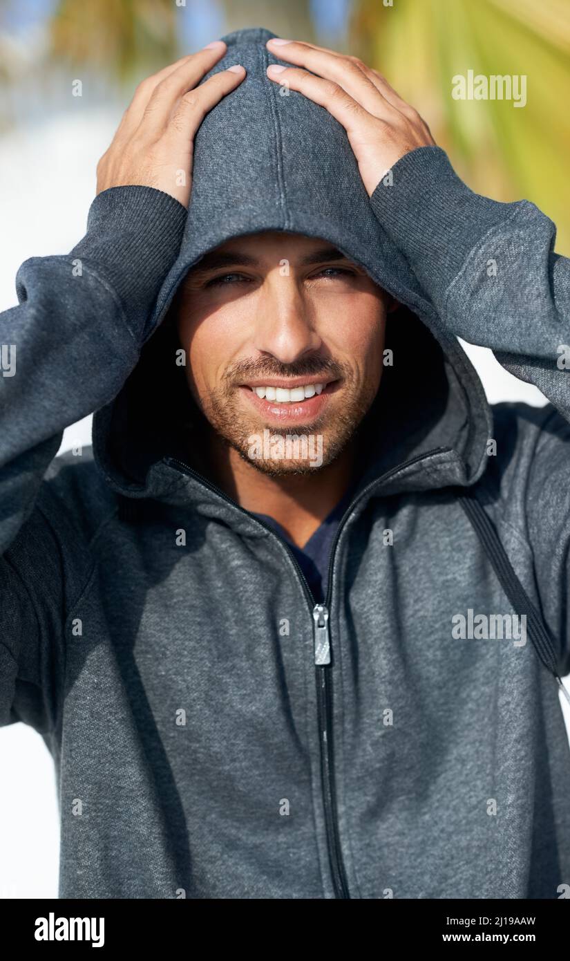 Hunk keeping his head warm. Portrait of a handsome young man wearing a ...