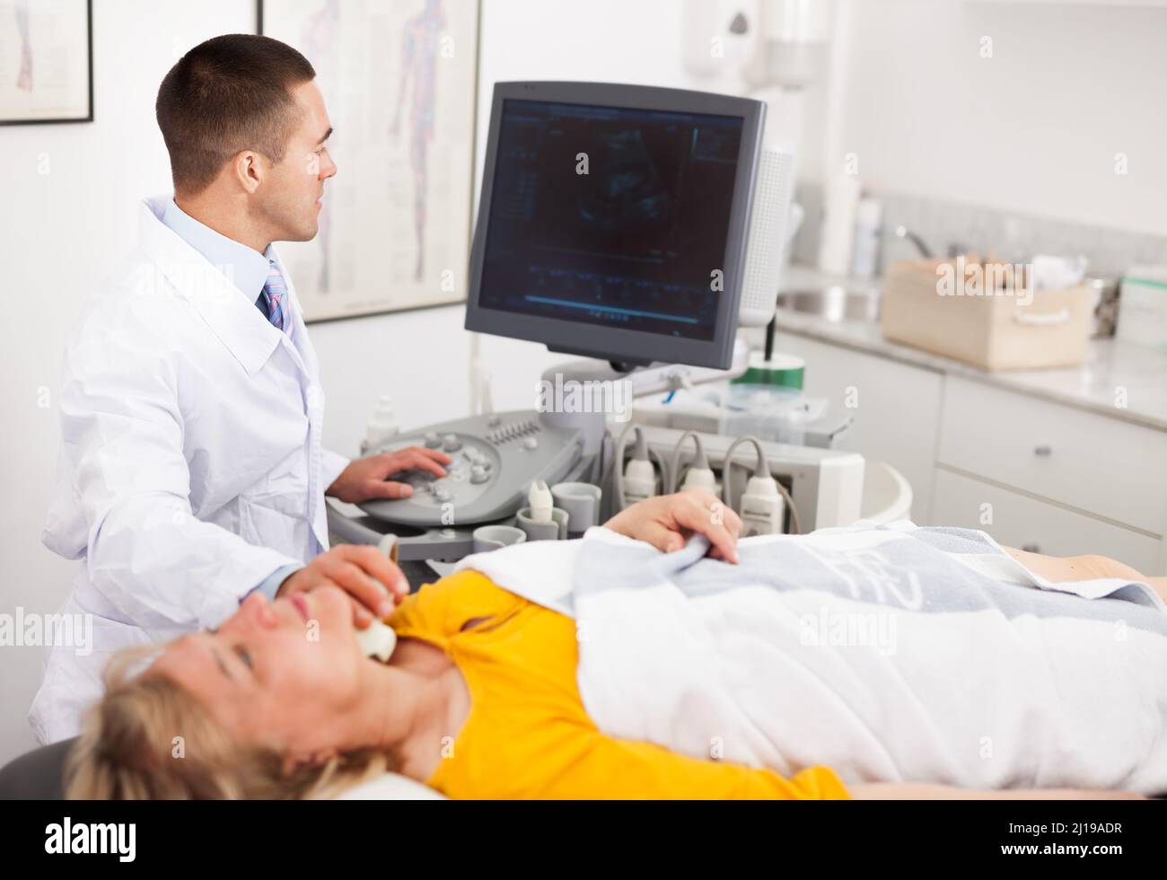 Doctor using ultrasound scan examining patient in hospital Stock Photo ...