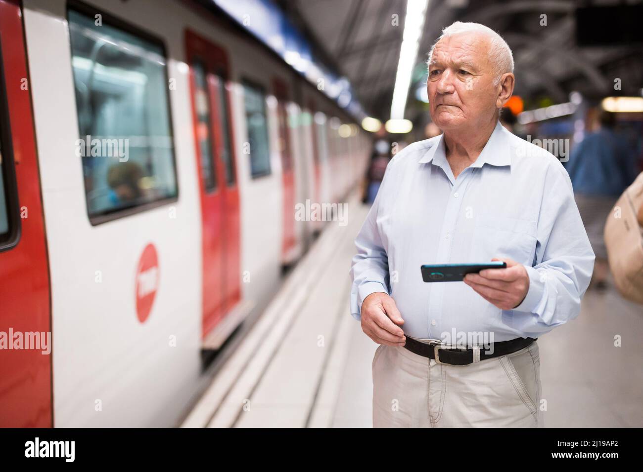 Elderly man in metro station Stock Photo - Alamy
