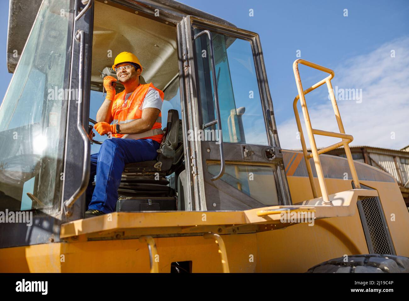 Multiracial man working hard at construction industry plant Stock Photo ...