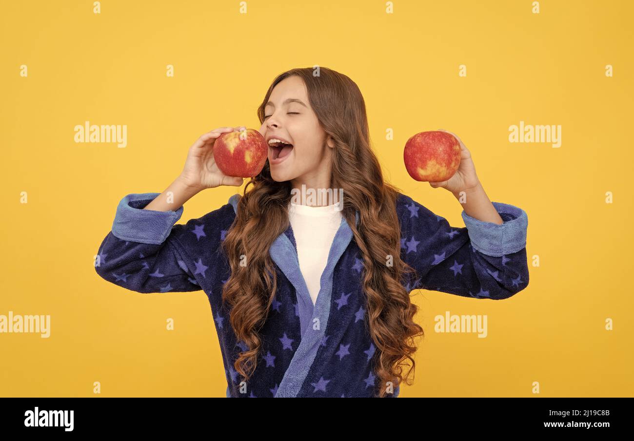 just one bite. happy teen girl with apple fruit. toothy kid has healthy ...