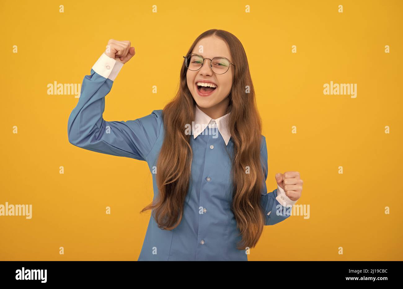 Education is the key to success. Happy tween girl show winning gesture ...