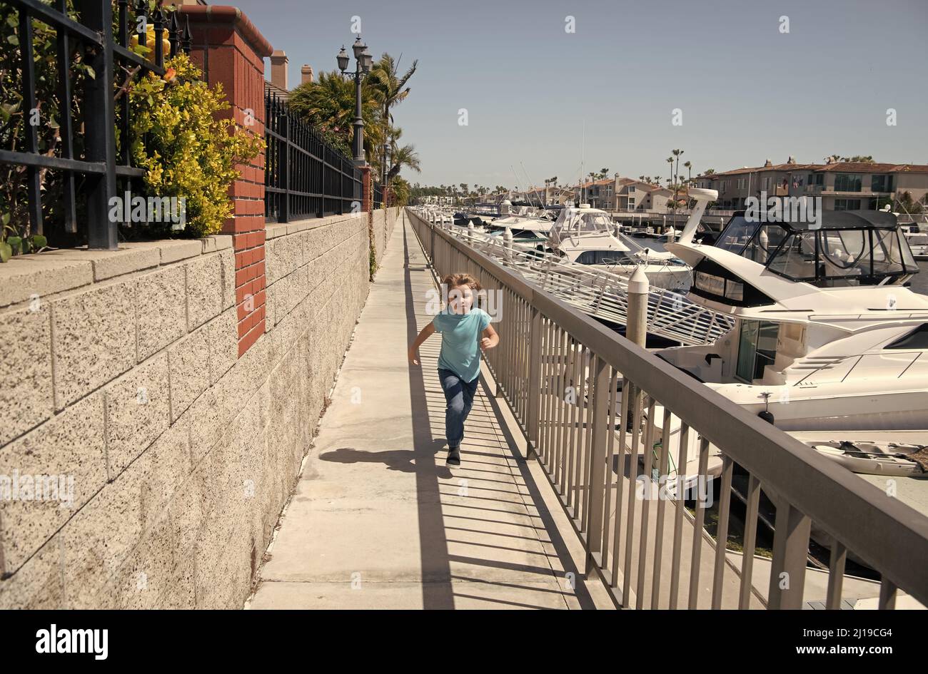 Active boy kid enjoy summertime running on promenade, summer activity ...