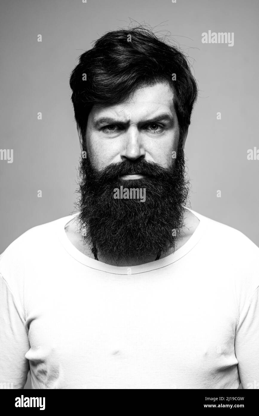Portrait of confident serious man has beard and mustache, looks ...