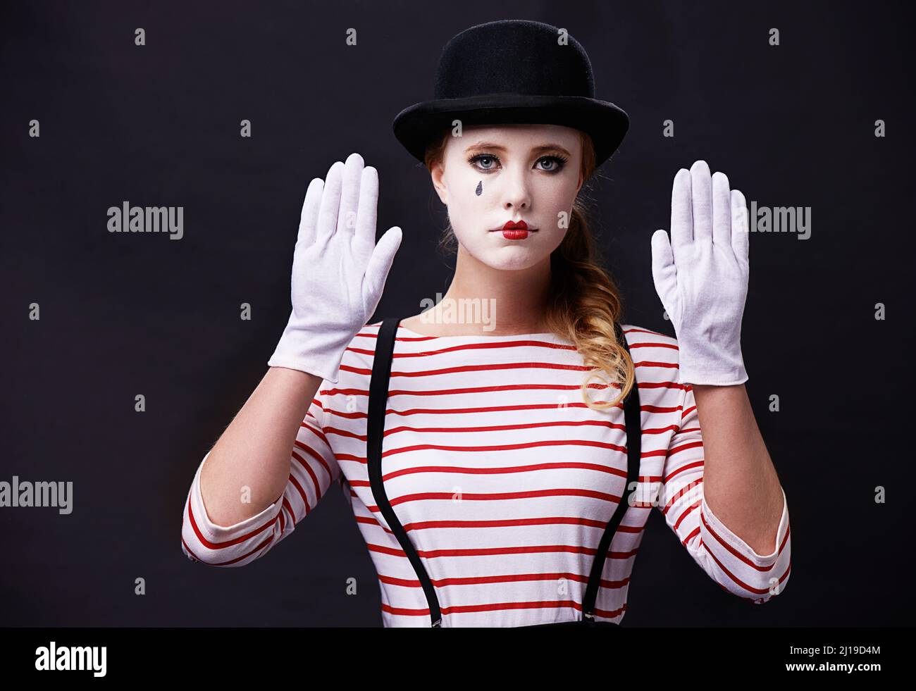 Where is this wall. Studio shot of a female mime Stock Photo - Alamy