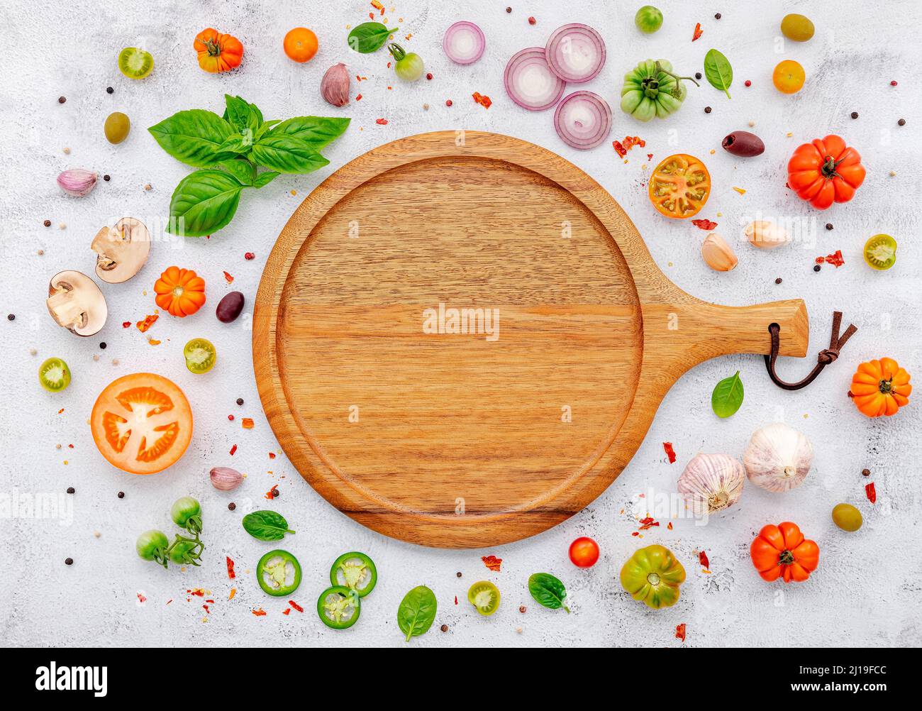 The ingredients for homemade pizza set up on white concrete background ...