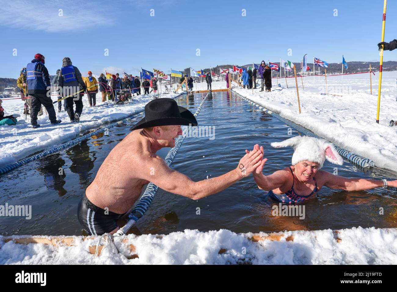 Cold water swimmers swim in the icy water of Lake Memphremagog near the ...