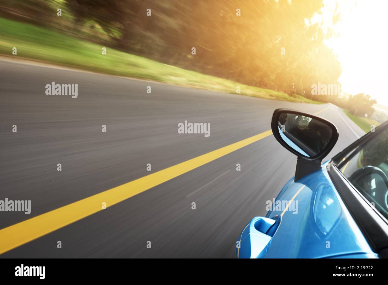 Cruising the open road. Shot of a car driving on a road Stock Photo - Alamy