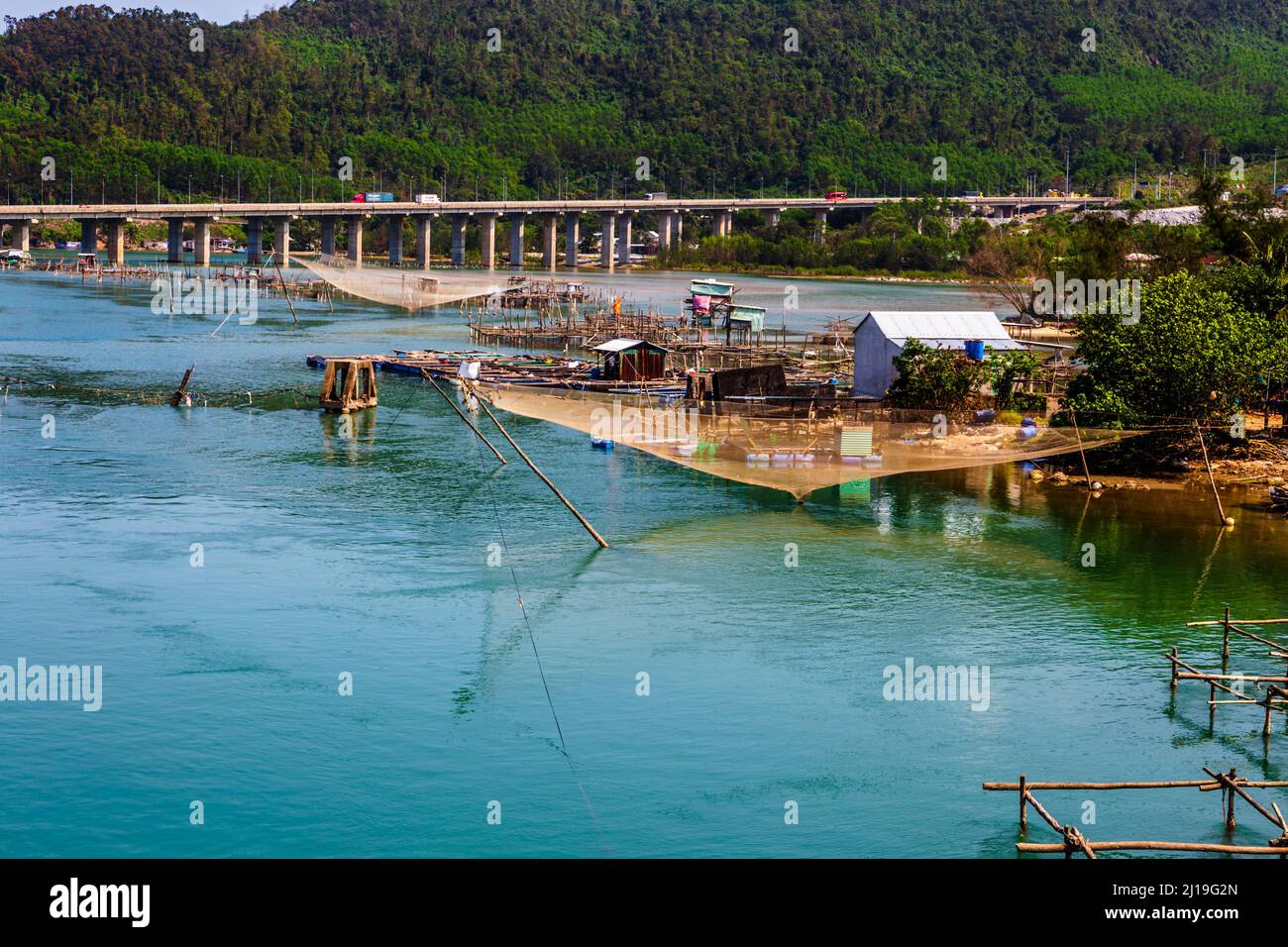 A small fishing village Lang Co inlet between several highway bridges ...