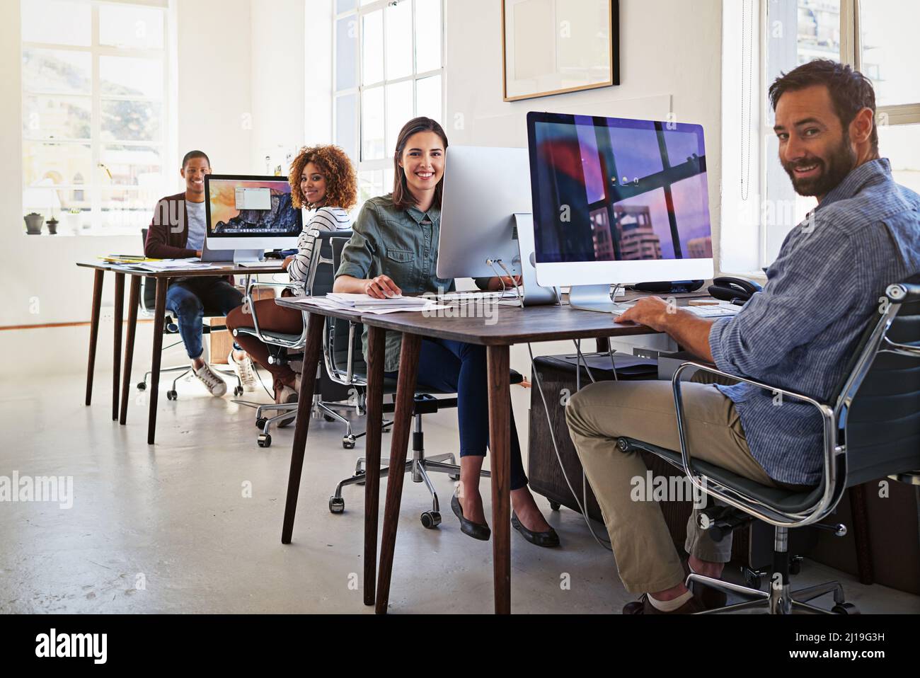 Their office is wired for success. Portrait of colleagues working on ...