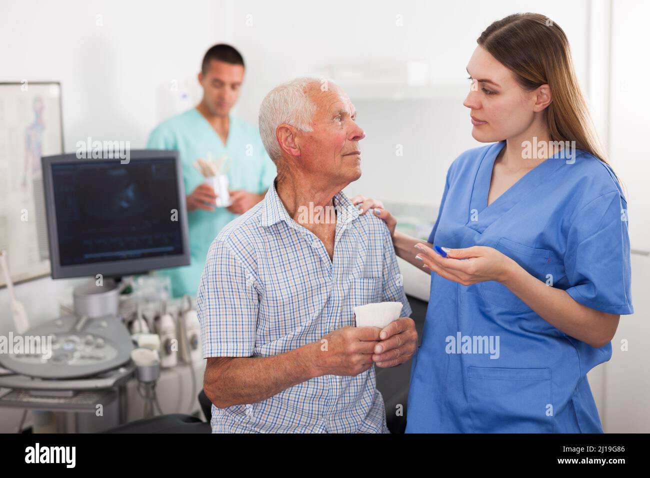 Sonographer talking with patient before procedure Stock Photo - Alamy