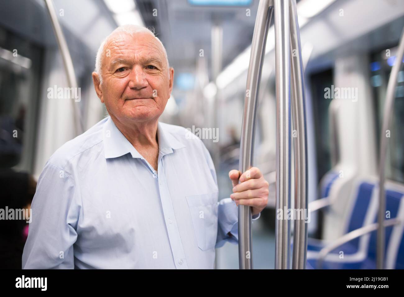 Elderly man in subway train Stock Photo - Alamy