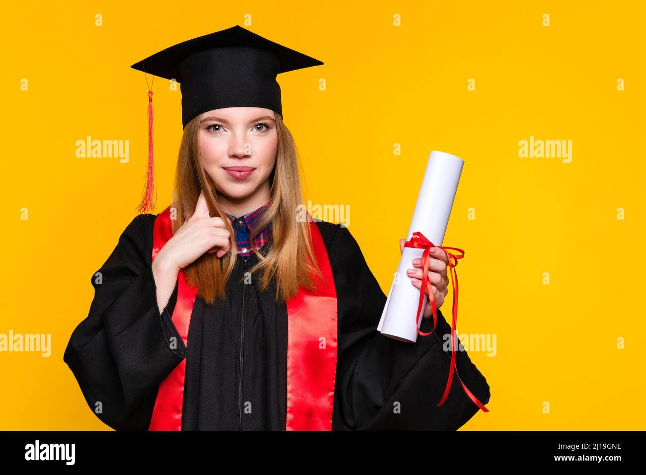 Portrait girl graduate with graduation hat and diploma on yellow ...