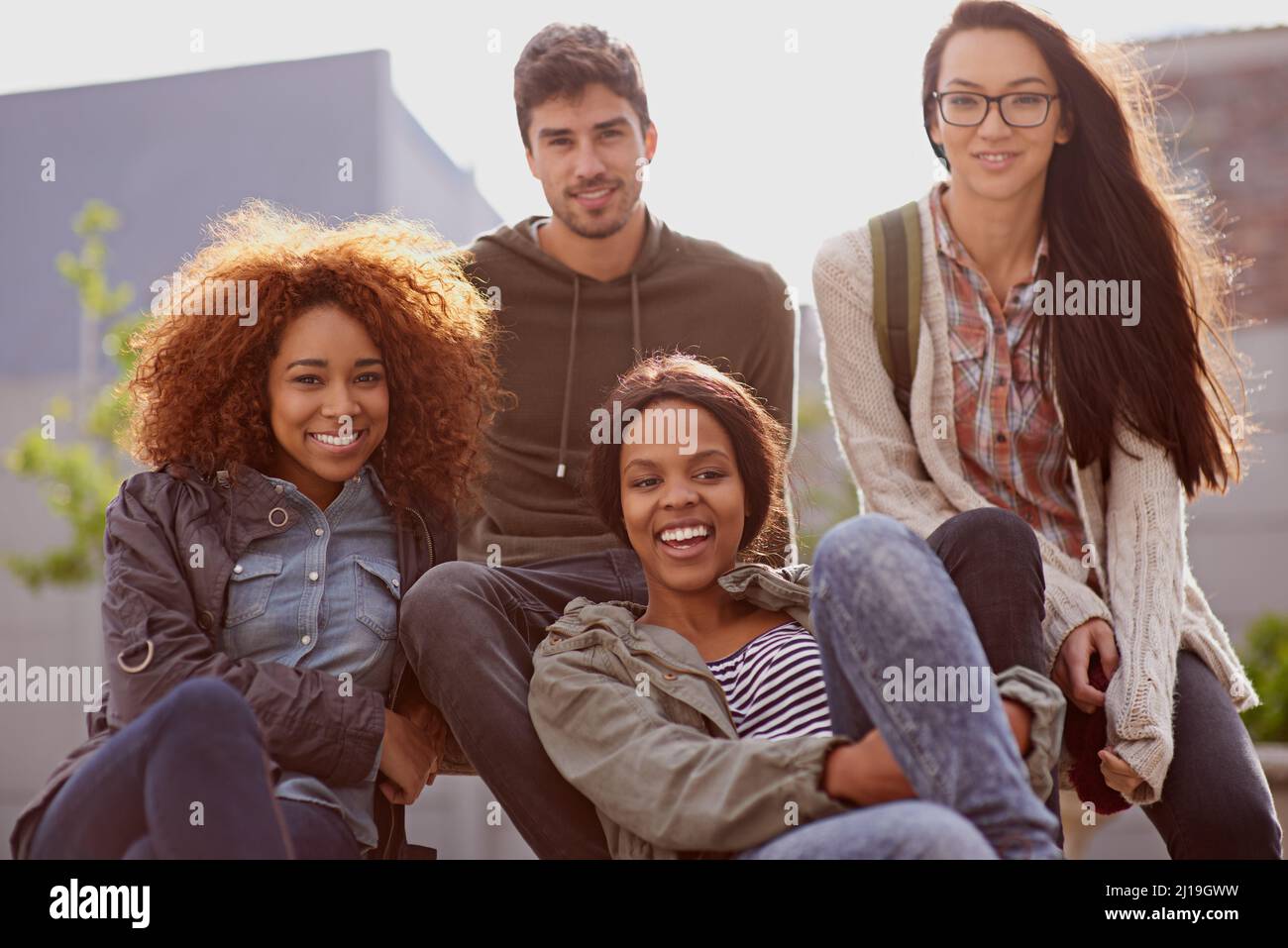 Making time for friends. Cropped shot of a group of students sitting ...