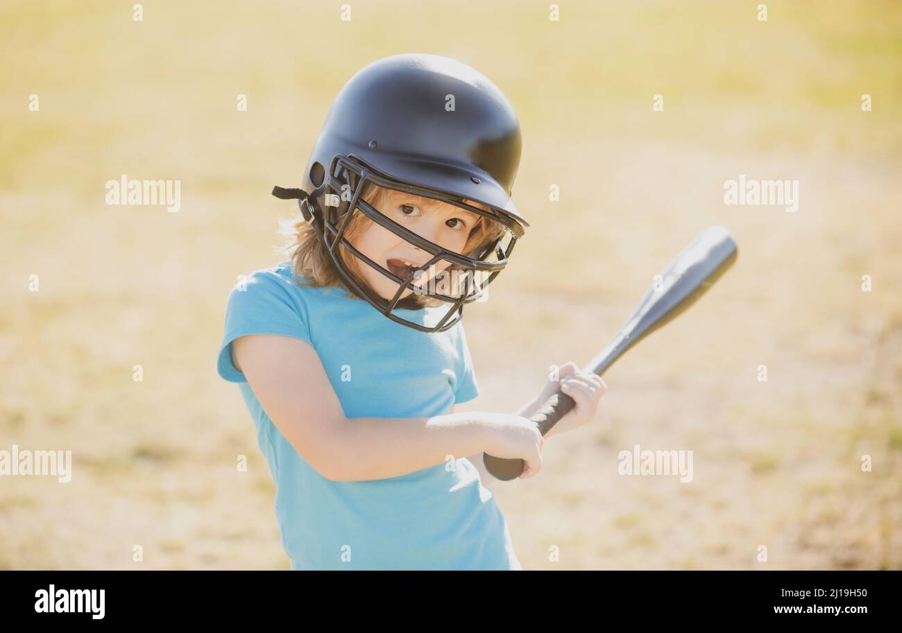 Funny boy kid holding a baseball bat. Pitcher child about to throw in ...
