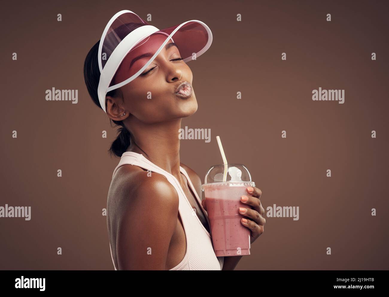 This smoothie makes me berry happy. Shot of an attractive young woman ...