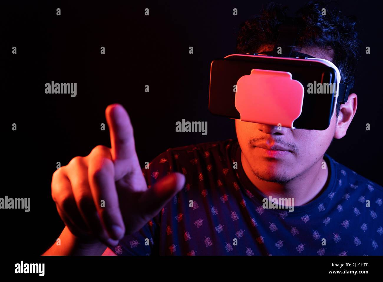 Young latin man using Virtual Reality VR Headset 3D Glasses and ...