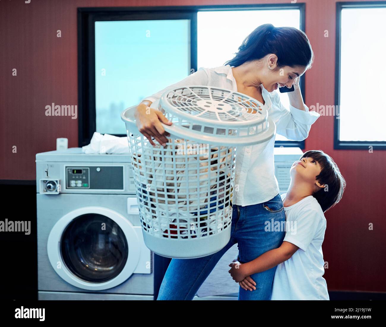 Lets first finish the laundry then we can play. Cropped shot of a young ...