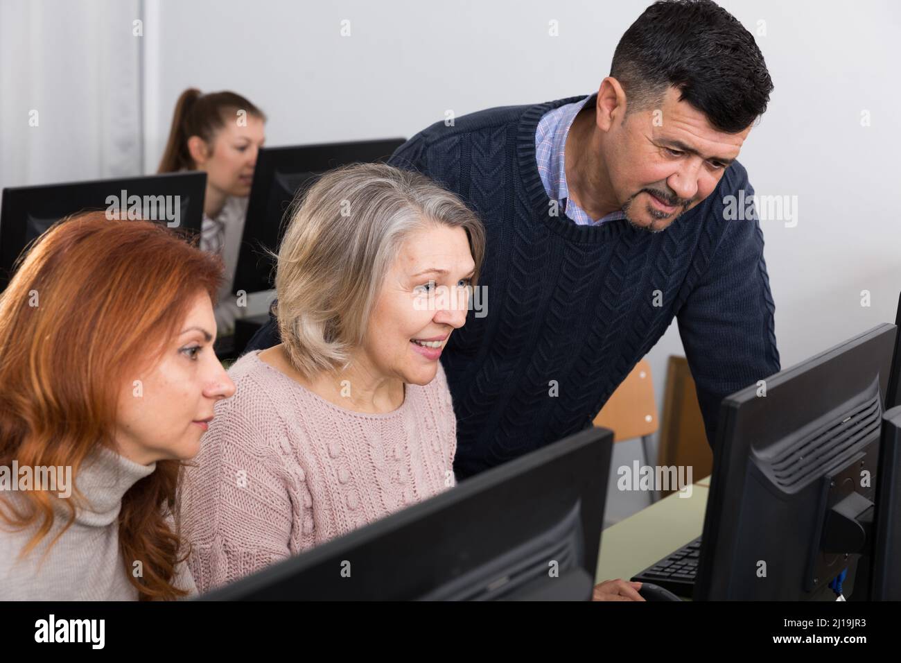Mature people working together on computer Stock Photo - Alamy
