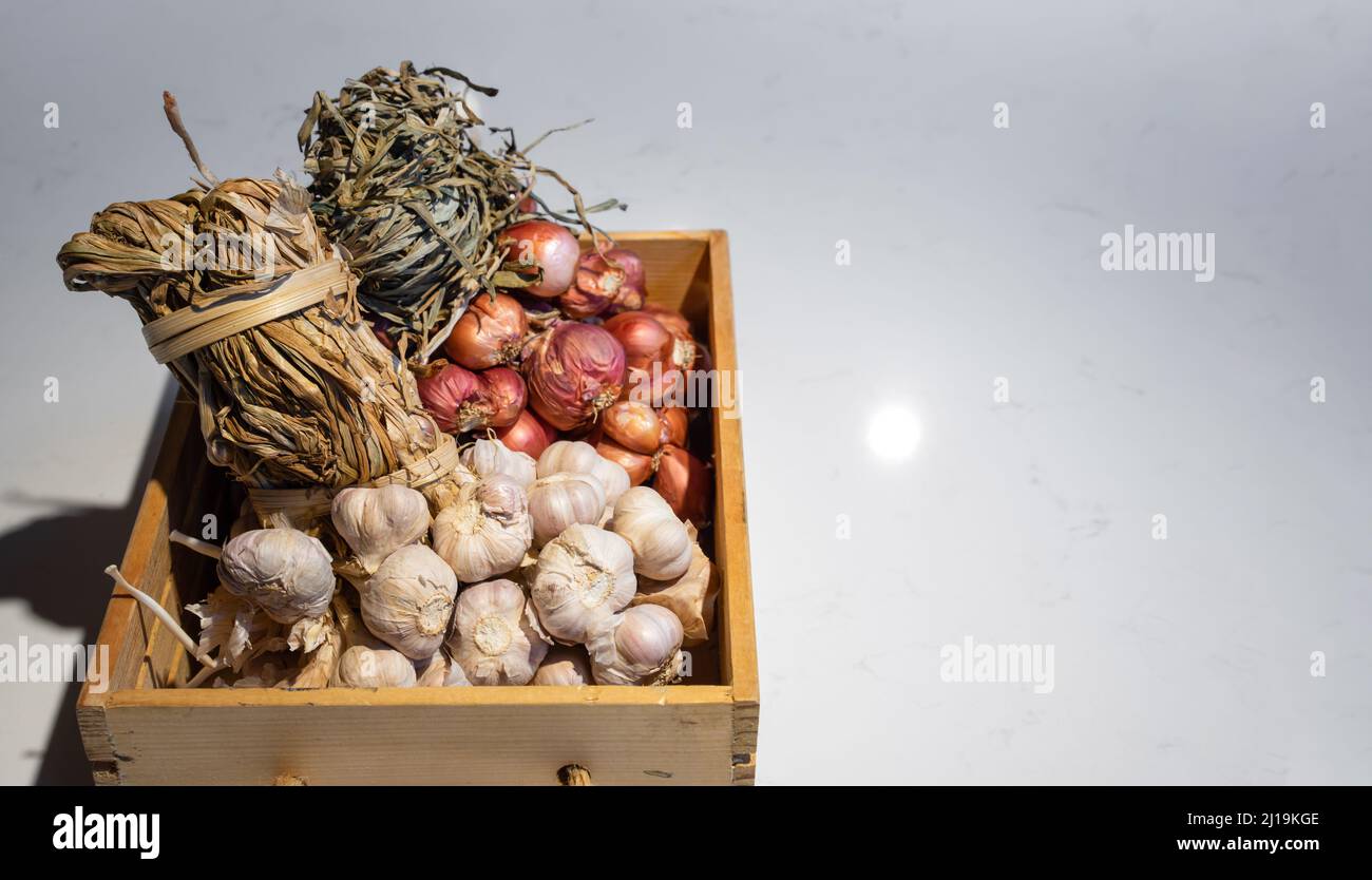 Garlic and Shallot Bundle in studio light on the white marble surface ...