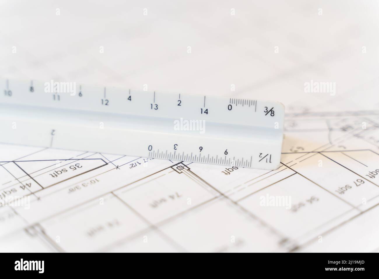 Architectural Scale Ruler with paper blueprints plans for new building ...