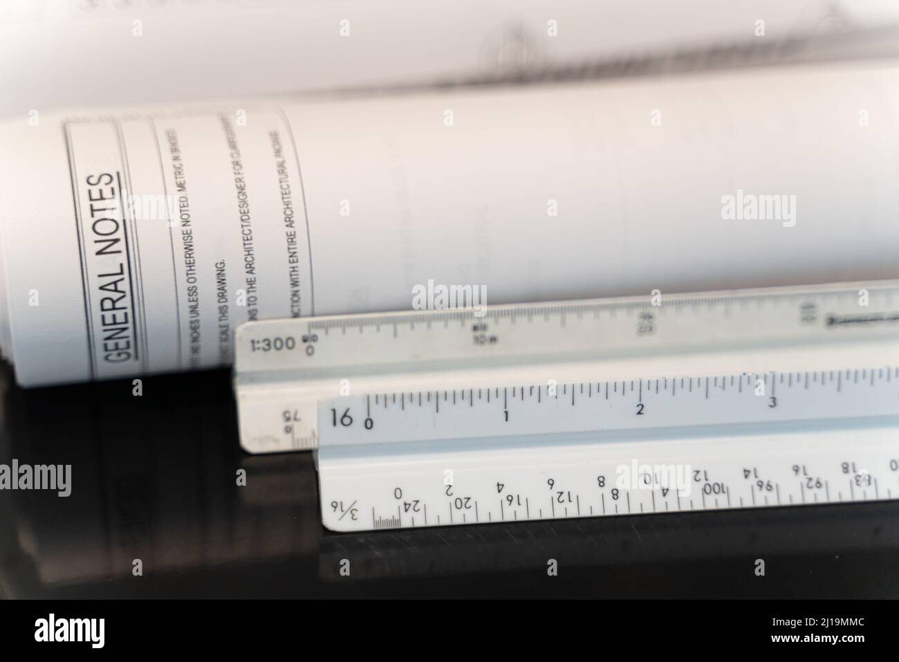 Architectural Scale Ruler with paper blueprints plans for new building ...