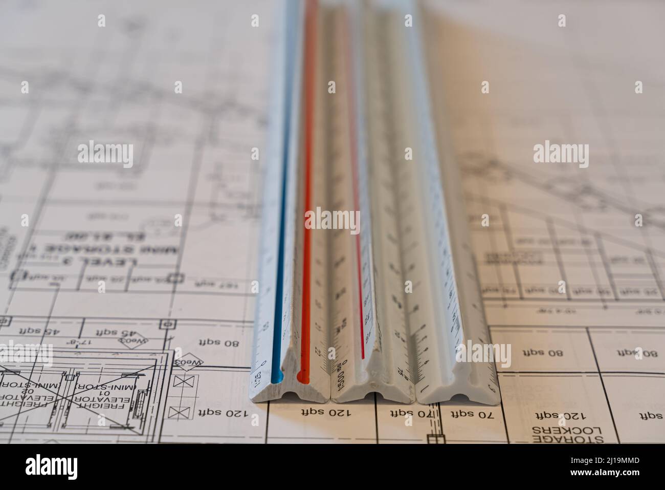 Architectural Scale Ruler with paper blueprints plans for new building ...