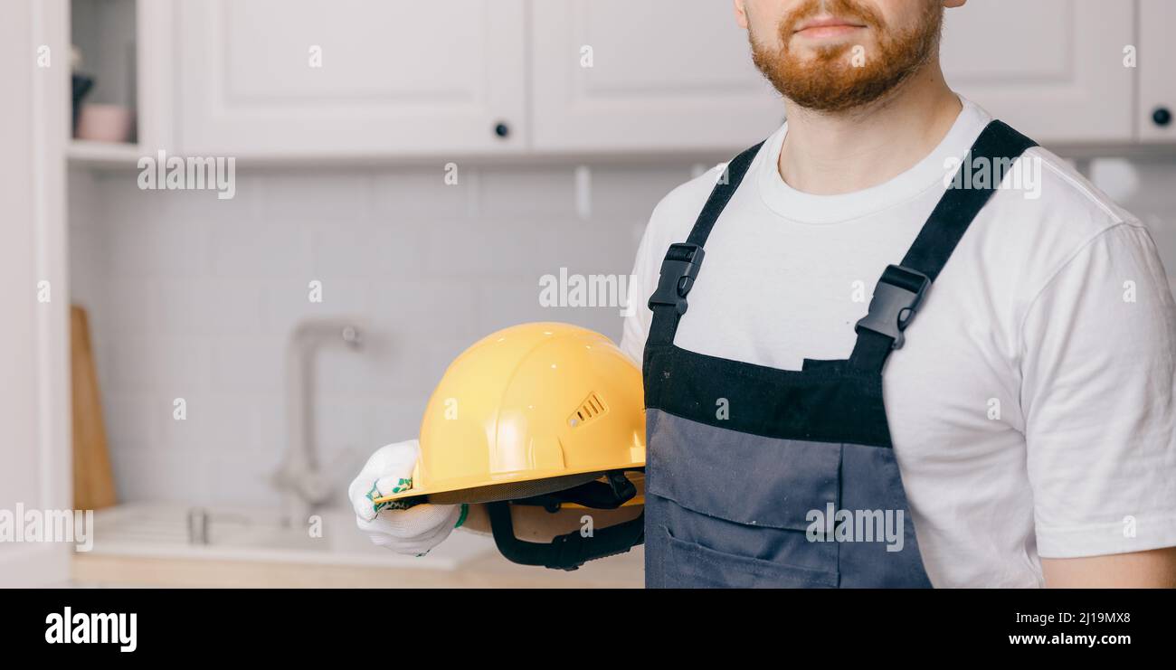 Banner man with helmet in hand copy space. Concept furniture assembly ...