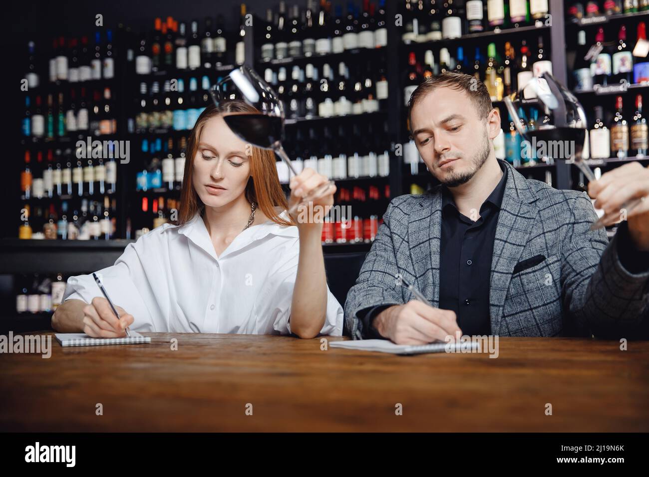 Tasting red wine Professional sommeliers two man and woman and taking ...