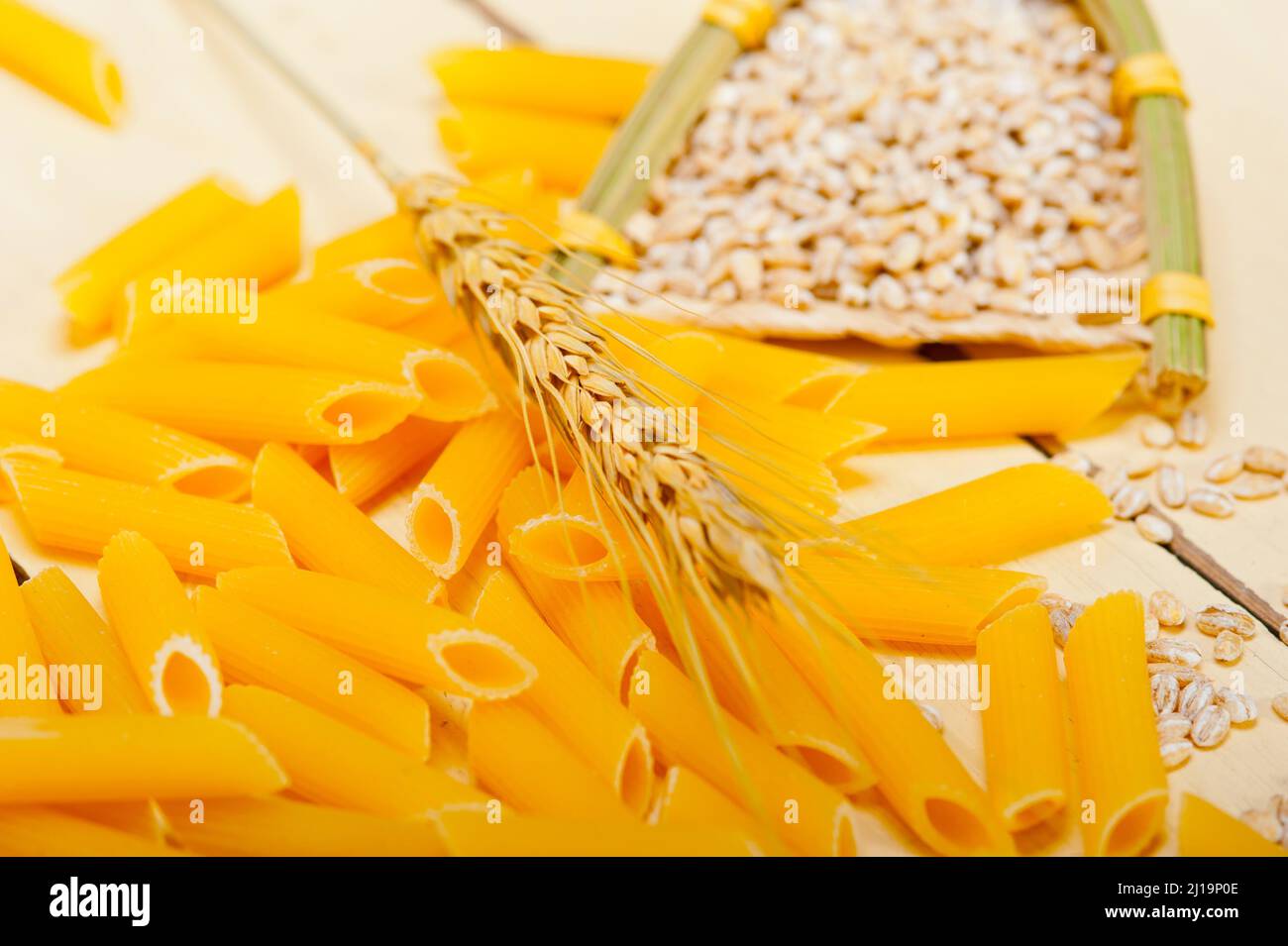 Short Italian pasta penne with durum wheat grains Stock Photo - Alamy