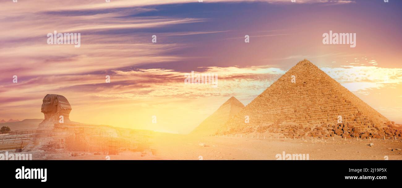 Pyramids of Giza in Cairo Egypt and Sphinx dramatic sunset sky. Banner ...