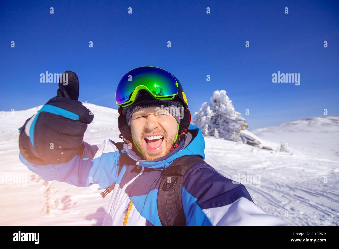 Winter recreation on nature ski tour, smile man skier makes selfie ...