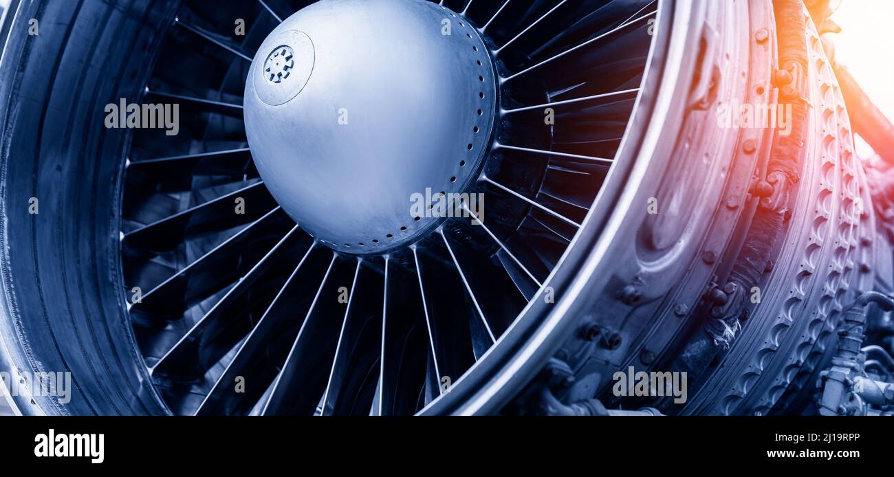 Closeup detail of turbine airplane engine blades. Blue color tone with ...