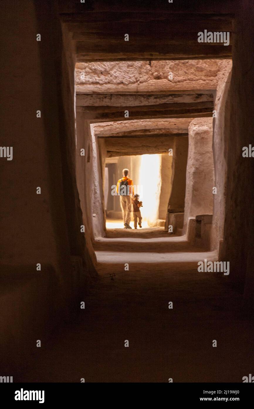 Aman and his daughter walking through tunnels of the unique mud city of ...