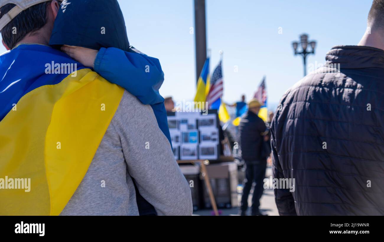 Father wearing Ukraine flag holding child at pro Ukraine rally Stock ...