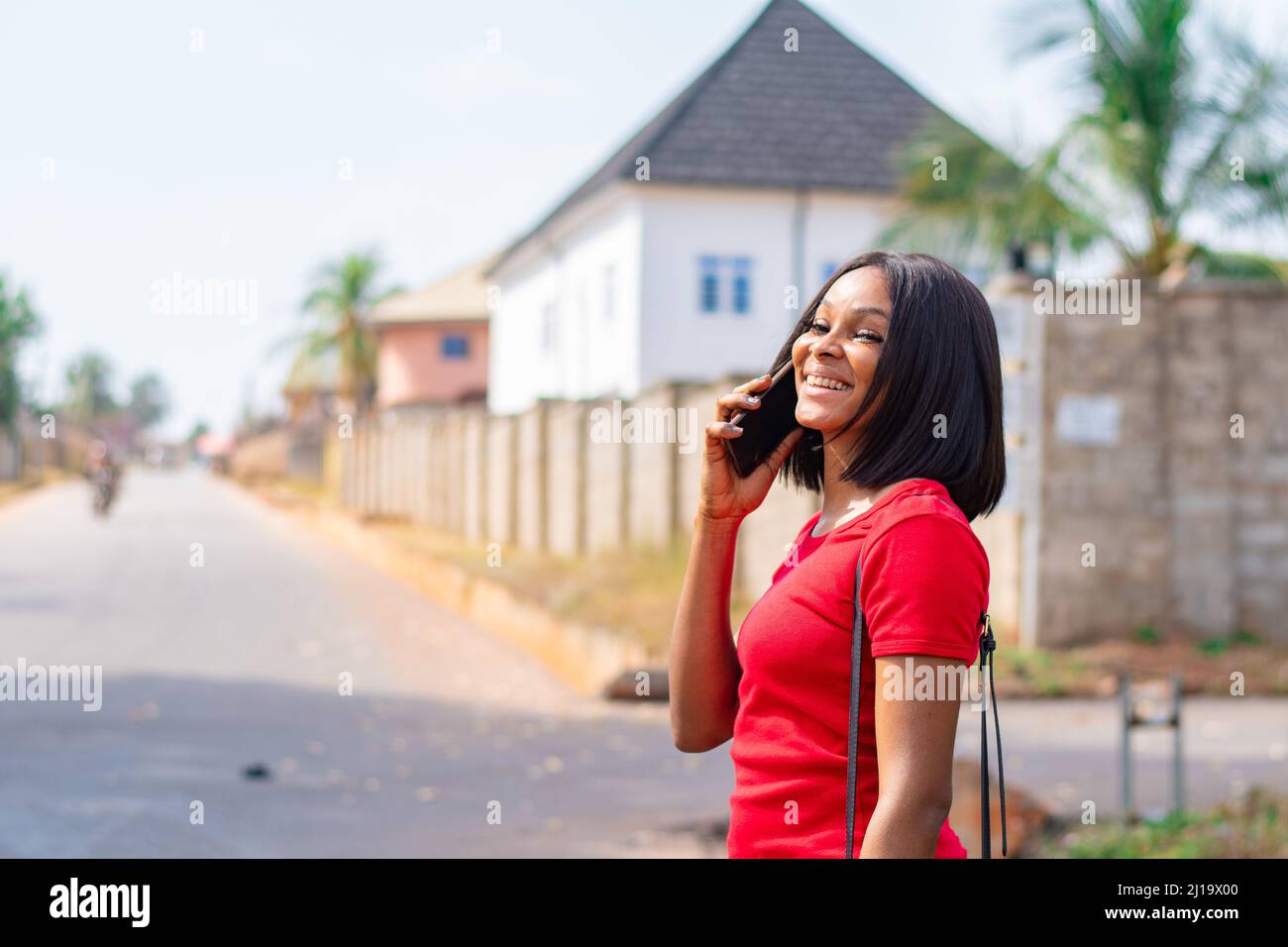 A beautiful Nigerian woman making phone call outdoors Stock Photo - Alamy