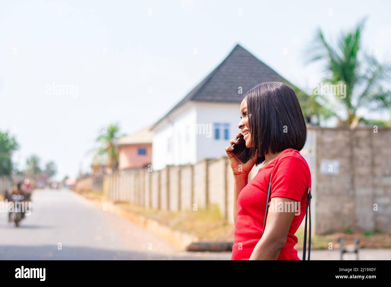 A beautiful Nigerian woman making phone call outdoors Stock Photo - Alamy