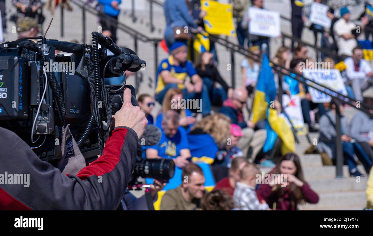 Cameraman filming crowd at Ukraine rally in Salt Lake City with signs ...