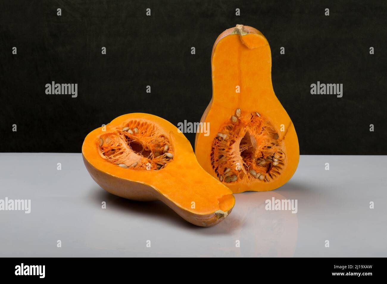 Still life with a pumpkin cut in half Stock Photo - Alamy