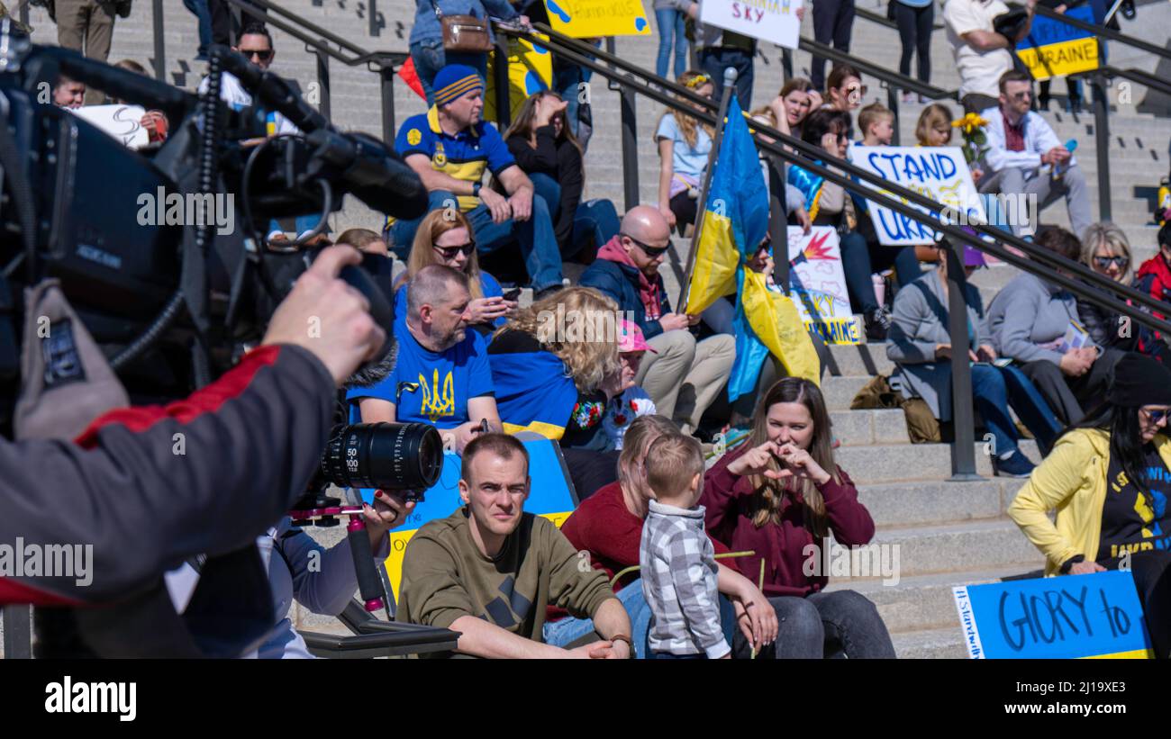 Cameraman filming crowd with signs, flags at Ukraine rally in Salt Lake ...