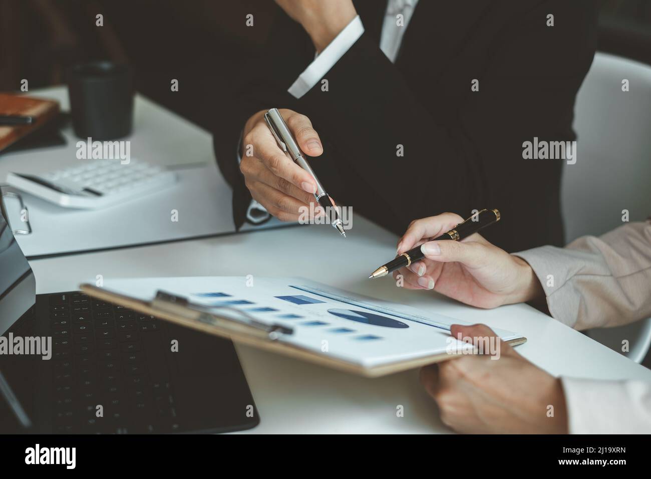 At the office desk, a company team is organizing a successful team ...