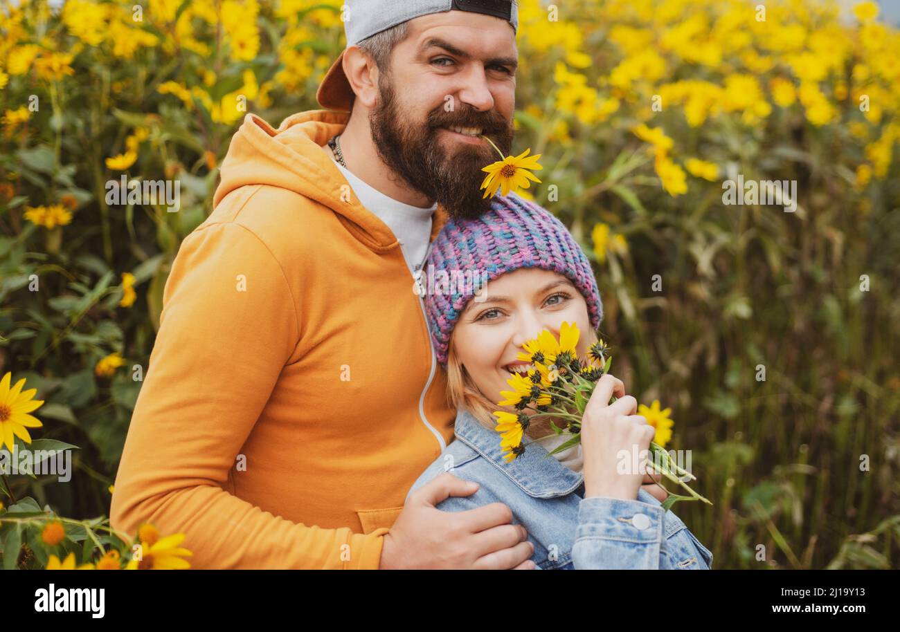 Young lovers hugging and embracing in autumn park with flovers. Couple ...