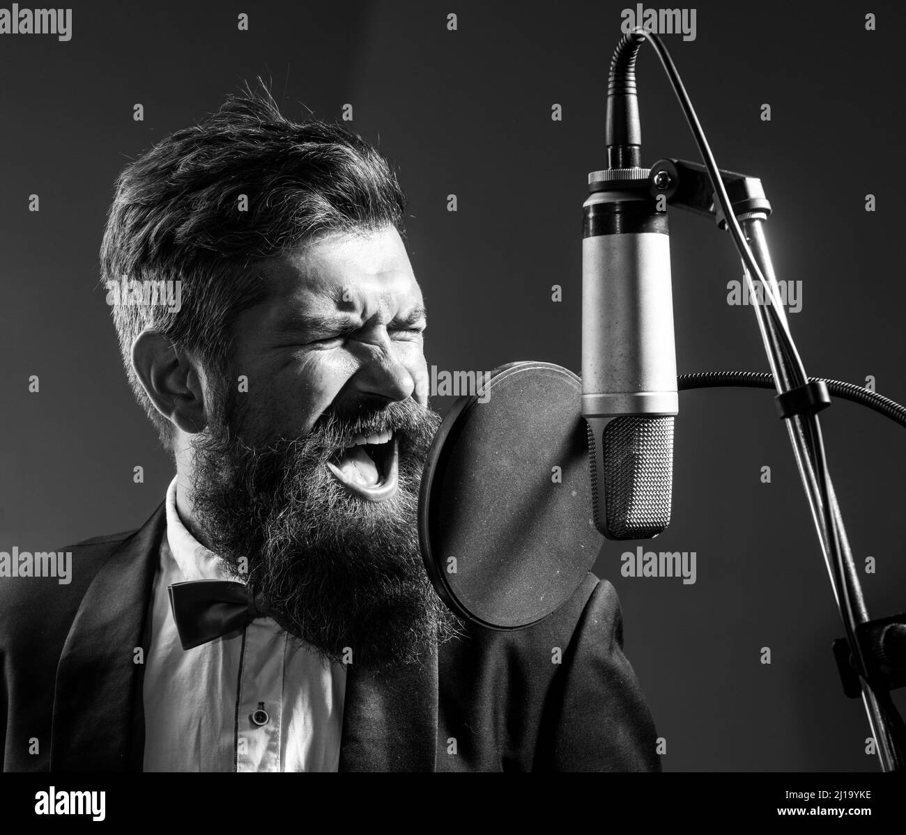 Karaoke singer. Man singing with music microphone. Classical music ...