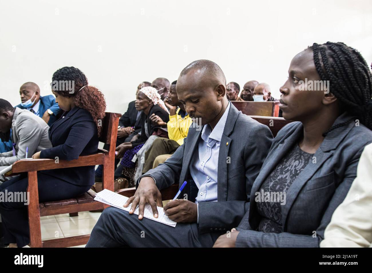 People follow court proceedings during the hearing of Mau Forest ...