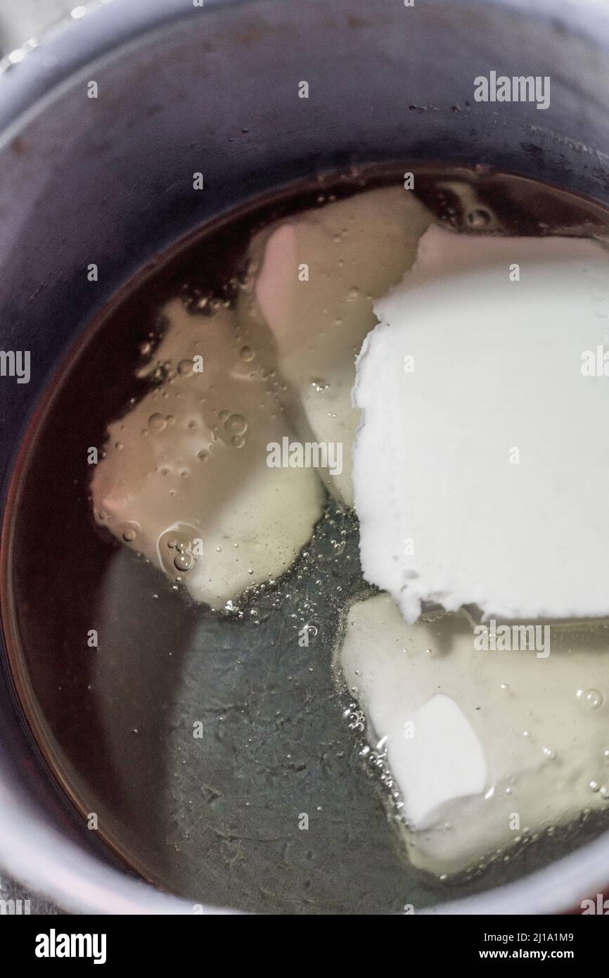 Lard fat in a pot is just melted and dissolves and becomes liquid in a ...