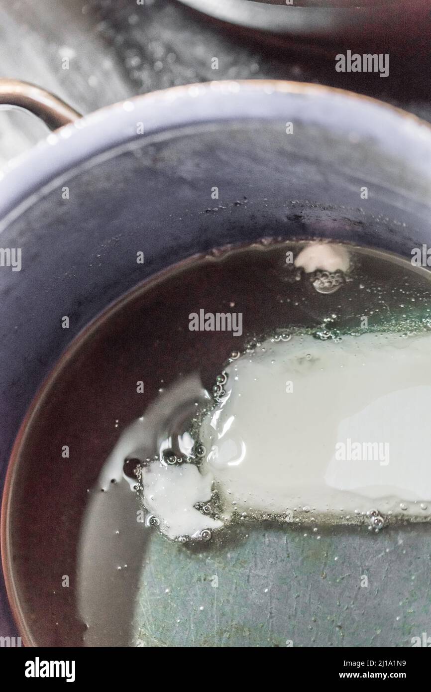 Lard fat in a pot is just melted and dissolves and becomes liquid in a ...